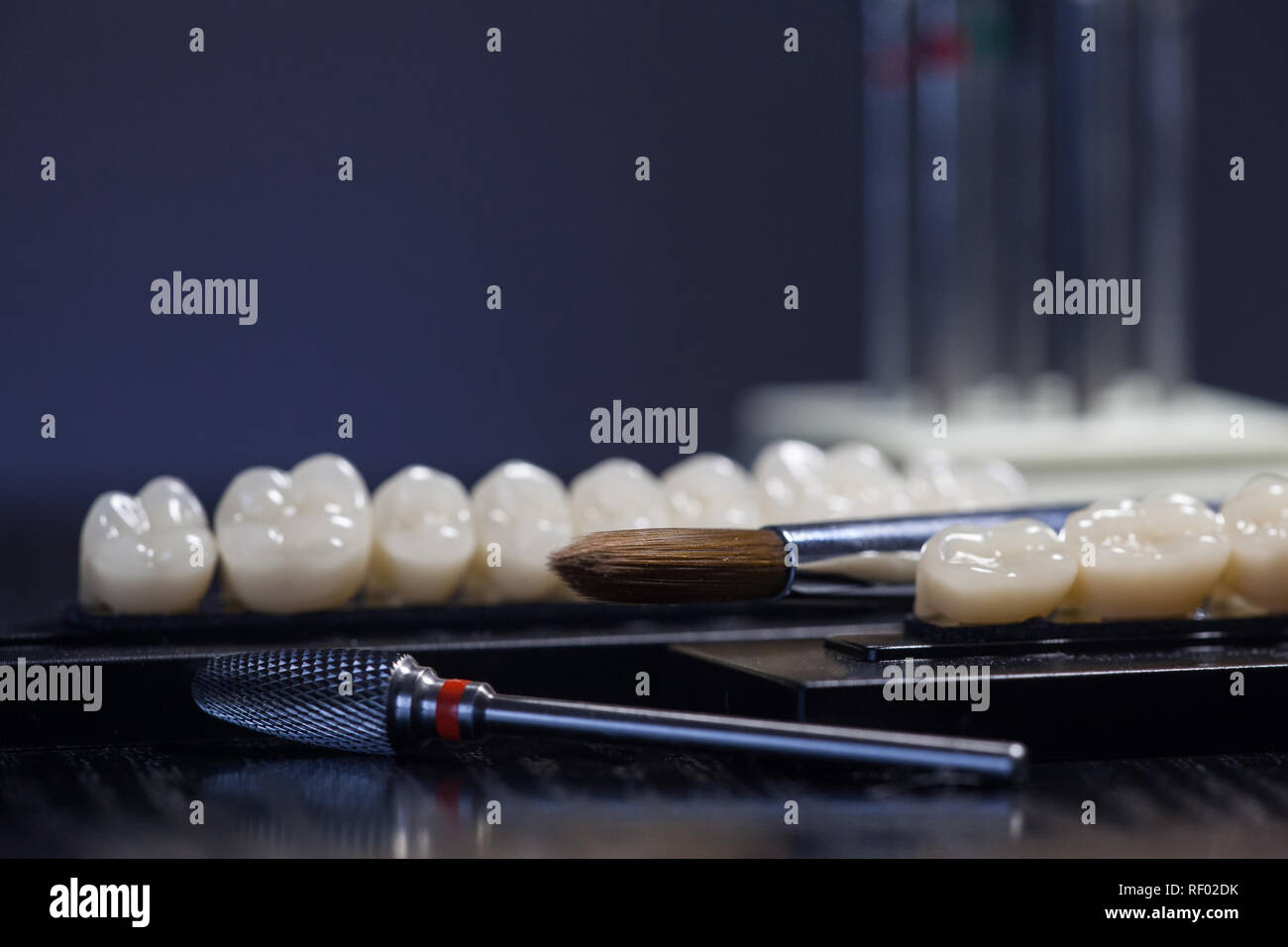 Acrylic teeth and dental instruments. Stomatologic instrument, close up ...