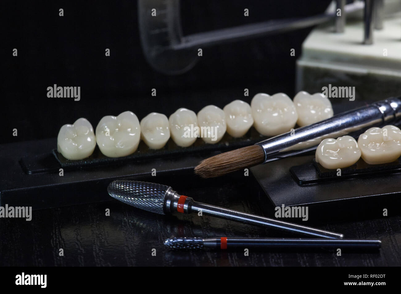 Acrylic teeth and dental instruments. Stomatologic instrument, close up ...