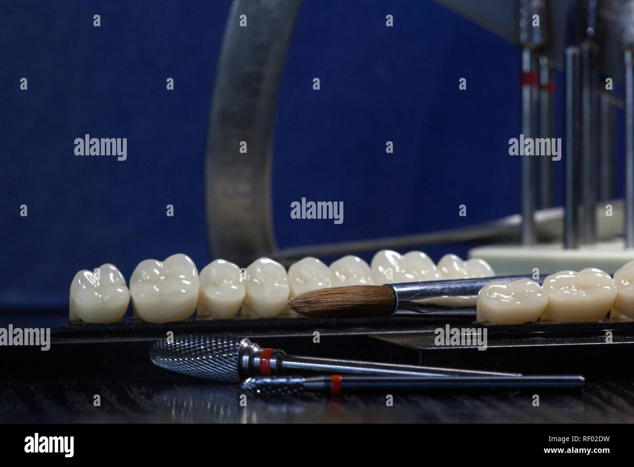Acrylic teeth and dental instruments. Stomatologic instrument, close up ...