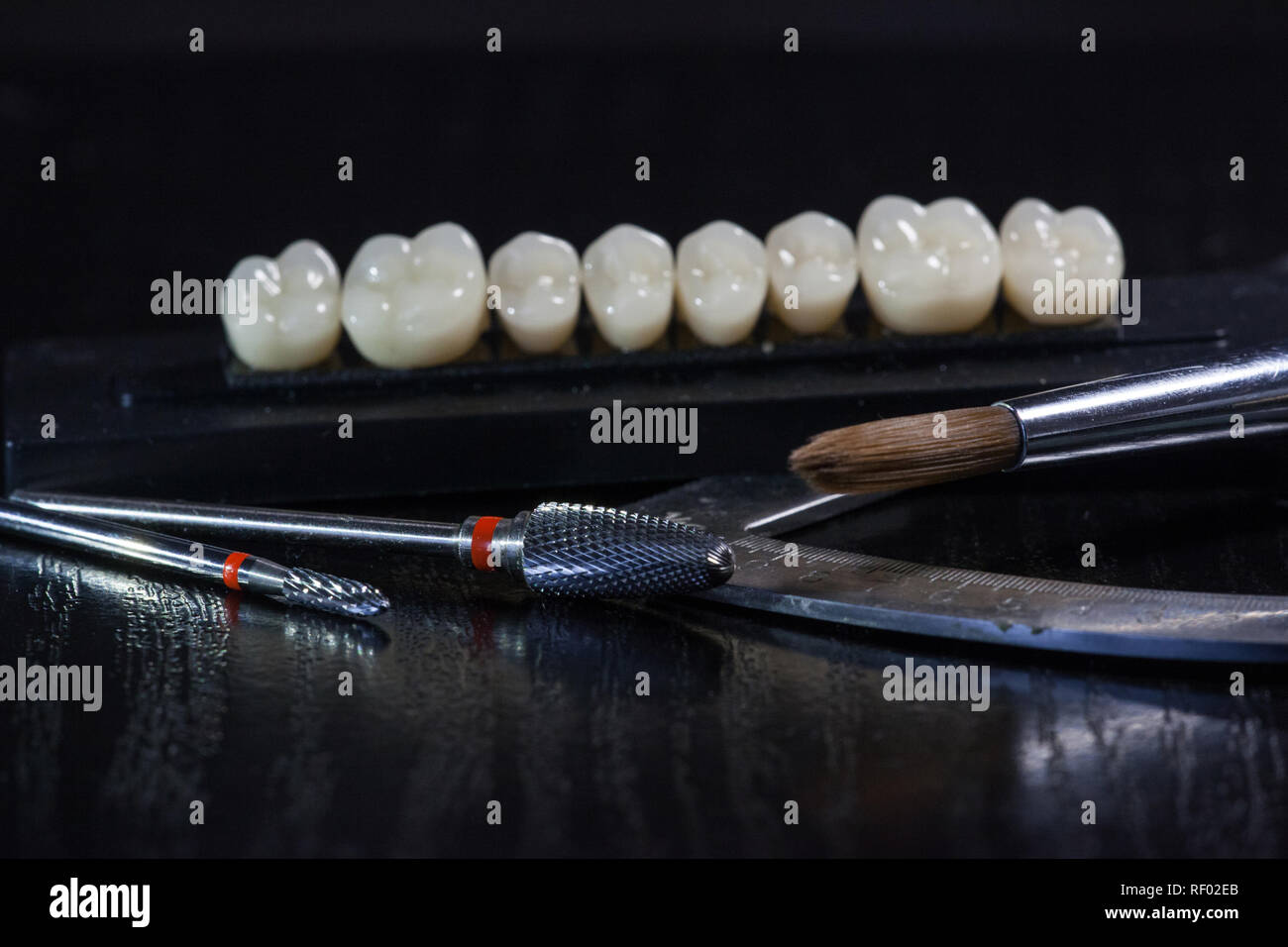 Acrylic teeth and dental instruments. Stomatologic instrument, close up ...