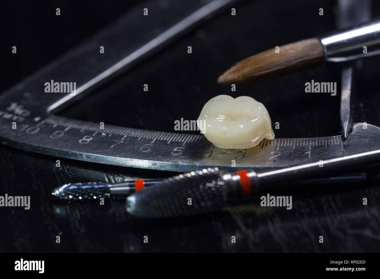 Acrylic teeth and dental instruments. Stomatologic instrument, close up ...