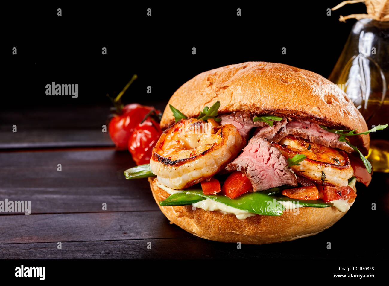 Gourmet Surf and Turf burger with medium rare roast beef and scampi ...