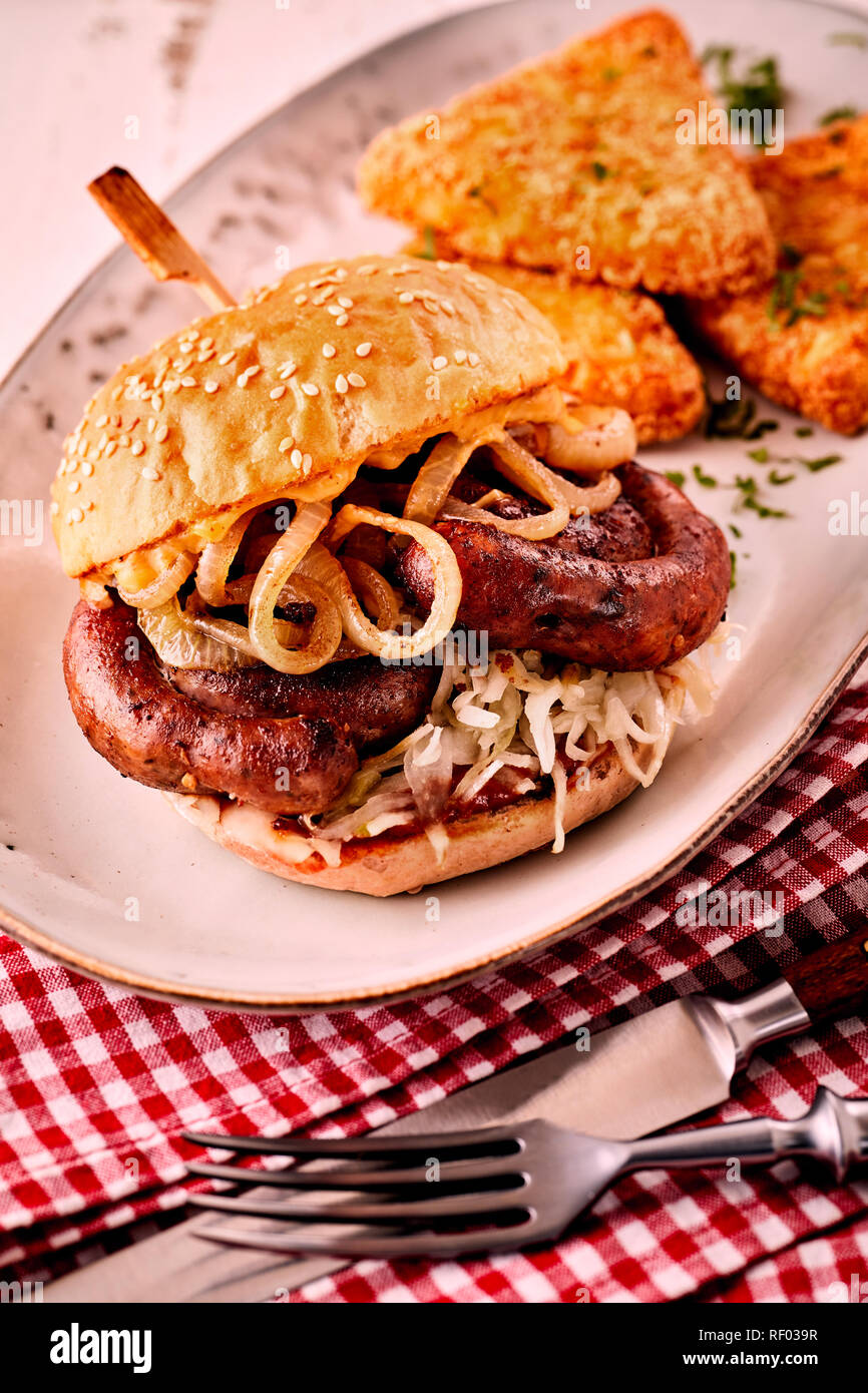 Tasty German bratwurst burger with spicy grilled pork sausage and onion ...