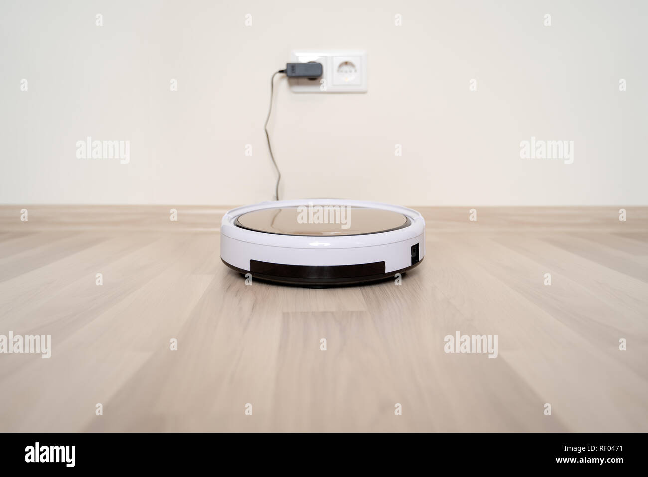 Robot vacuum cleaner on charging dock after it is finished Stock Photo ...