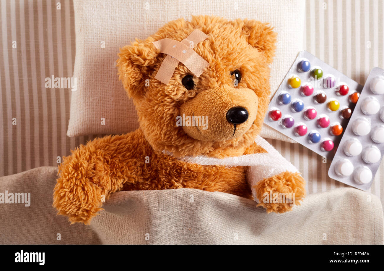 Healthcare concept of injured teddy bear with sticking plaster on head ...
