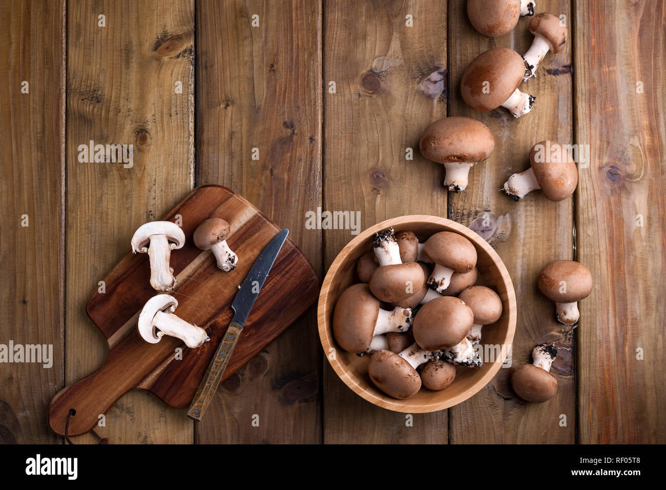 Champignon mushrooms, sacking mat and spices on wooden background ...