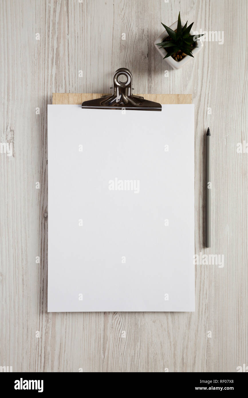 Workspace with clipboard, sheet of paper and pencil, view from above ...