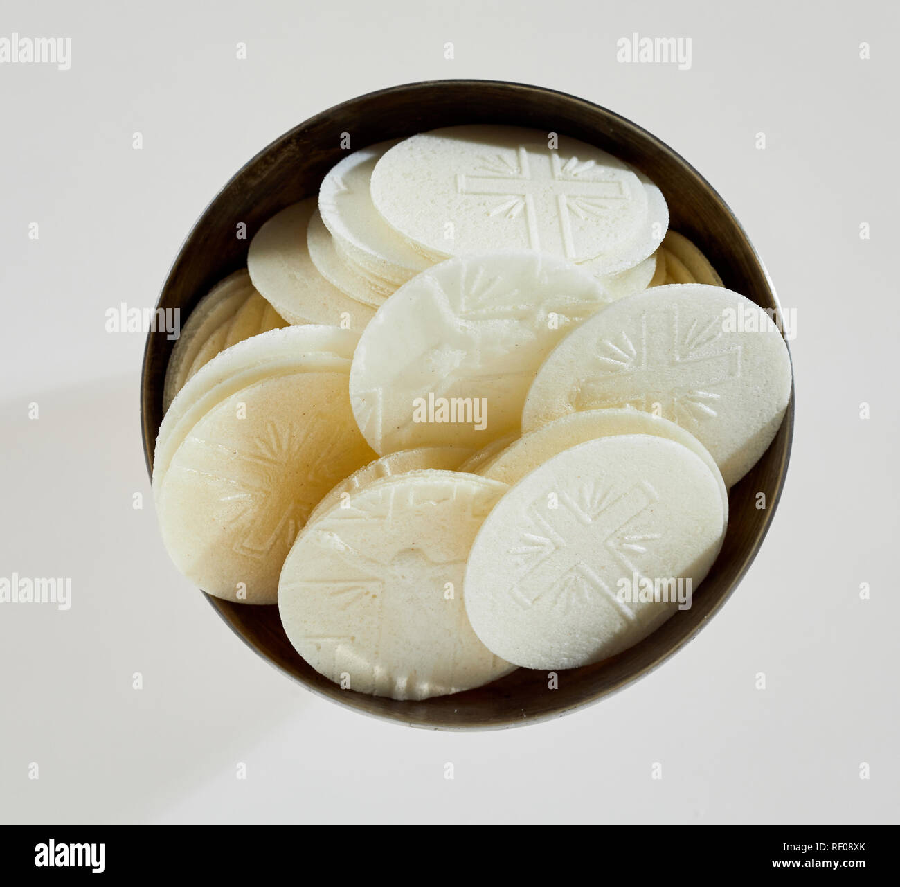 Bowl full of consecrated Hosties for Holy Communion symbolic of the ...