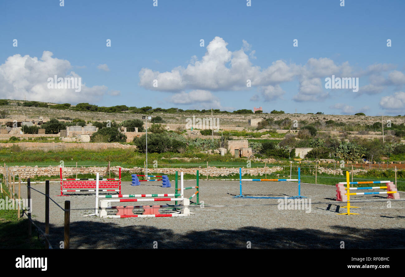 Ground for training horses with obstacles, sunny day, sky and clouds ...