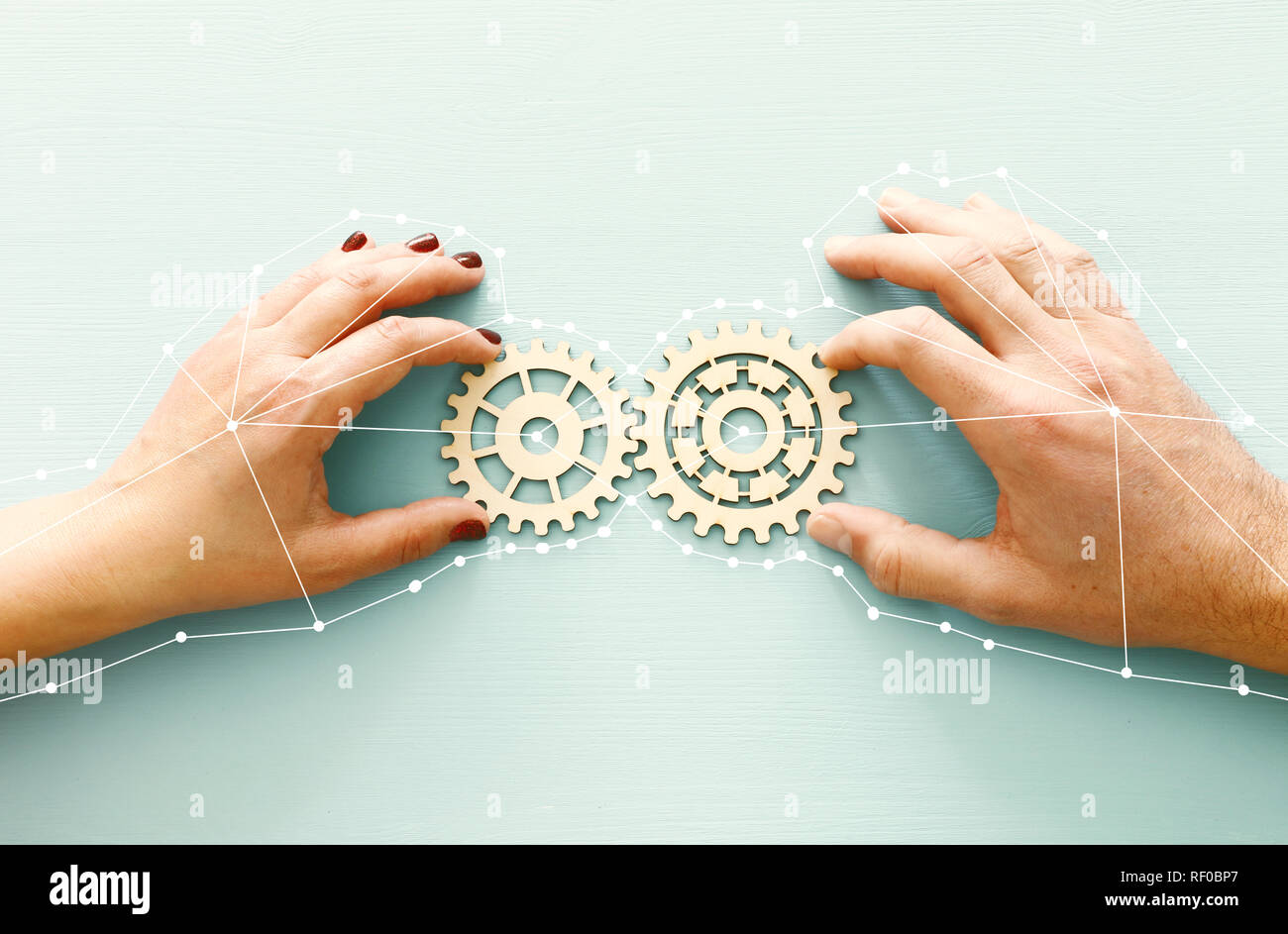 hand placing a cogwheel in set of gears mechanism Stock Photo - Alamy