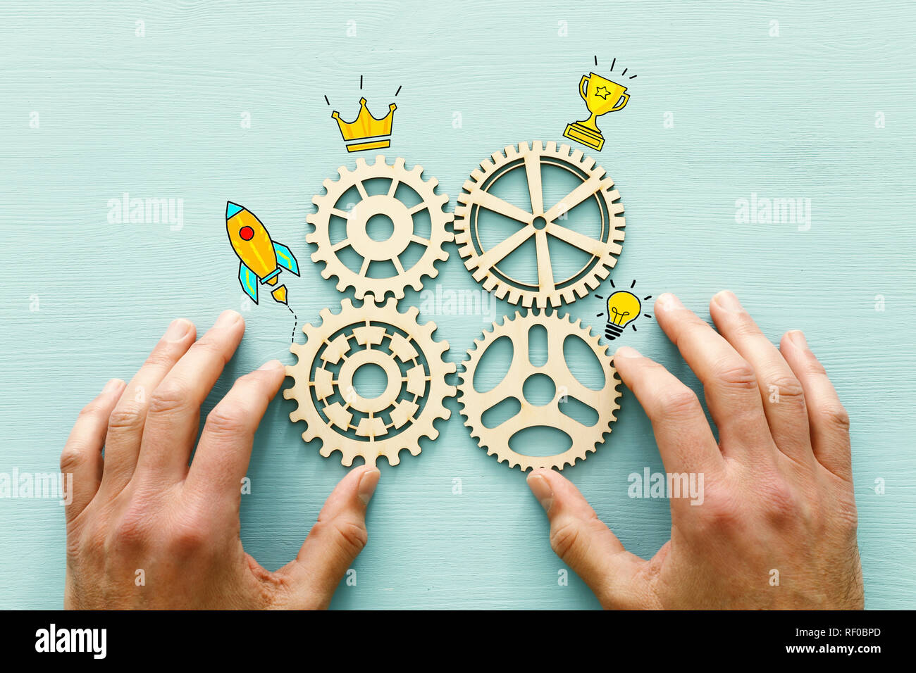 hand placing a cogwheel in set of gears mechanism Stock Photo - Alamy