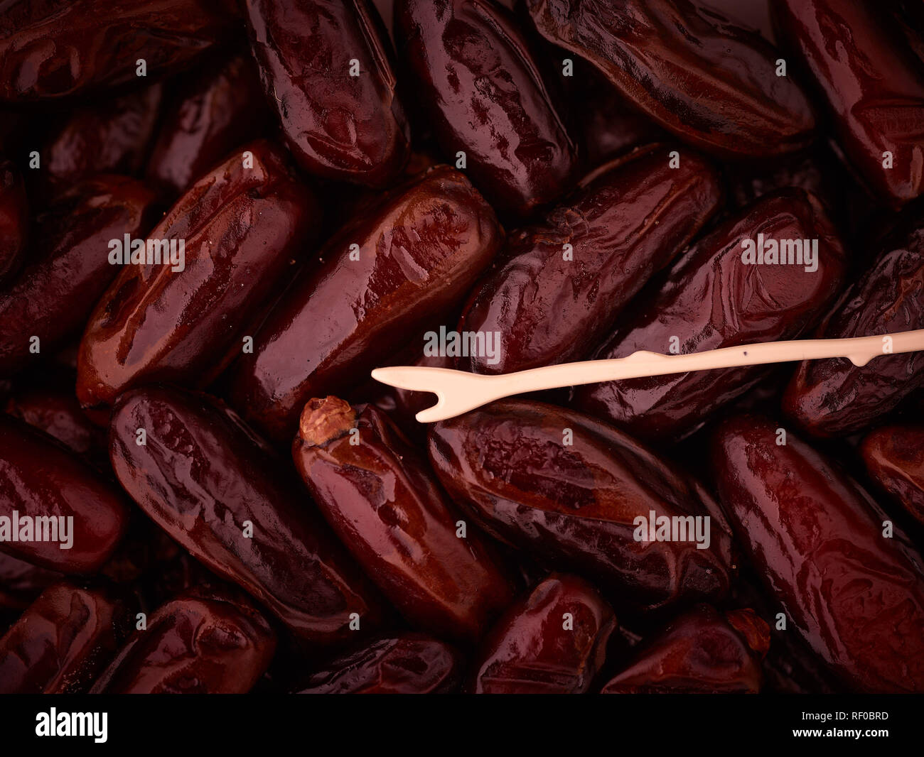 Date fruit with date pick , food still-life photograph Stock Photo - Alamy