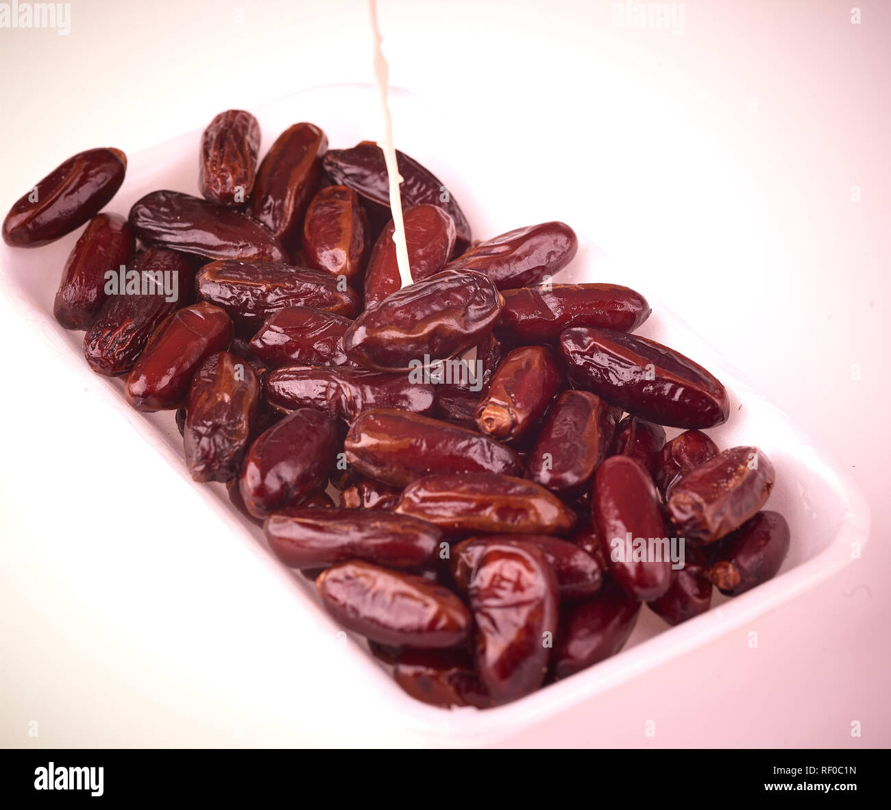 Date fruit with date pick , food still-life photograph Stock Photo - Alamy