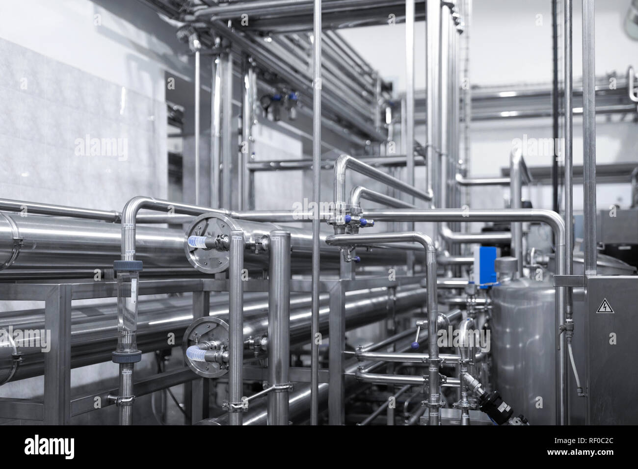 Steel pipelines and cables in factory interior as pharmaceutical ...