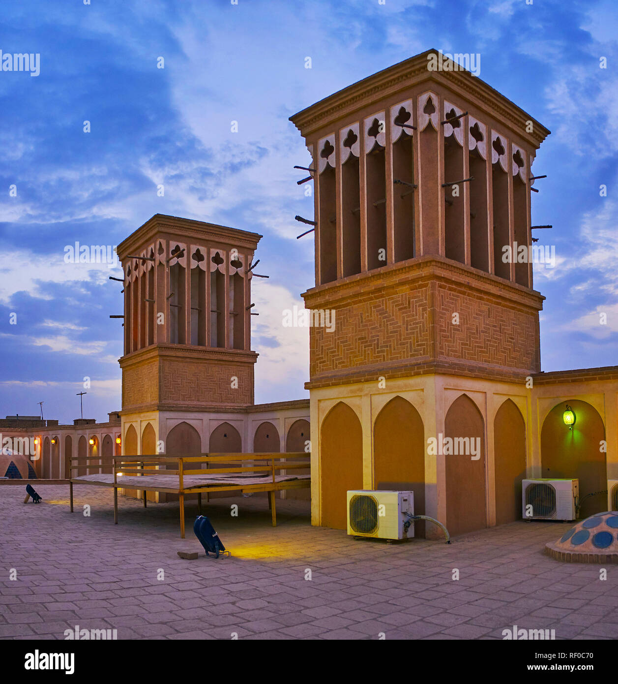 The twilight cloudy sky above the medieval badgirs (wind towers) of ...
