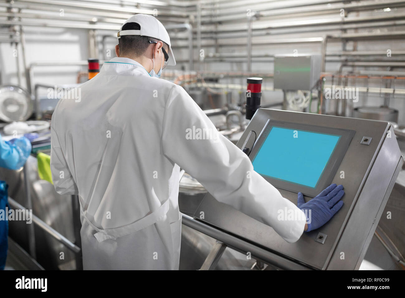 technologist taking necessary notes while standing at production ...