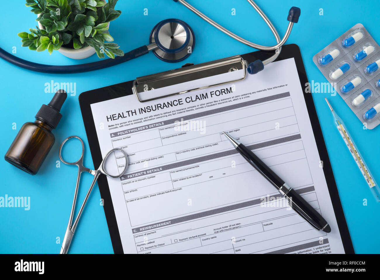 Health insurance form and pen on doctor desk, top view, blue background ...