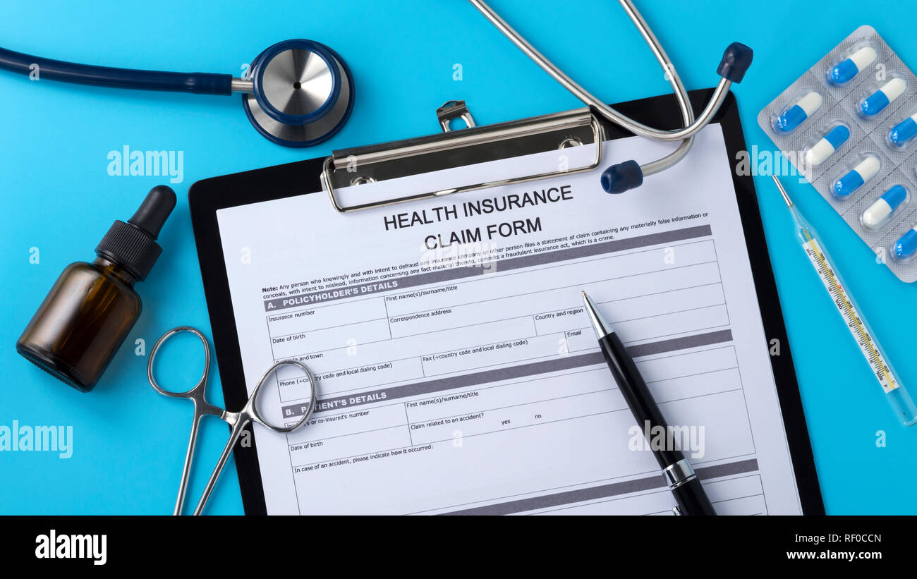 Health insurance claim form with pen on blue background Stock Photo - Alamy