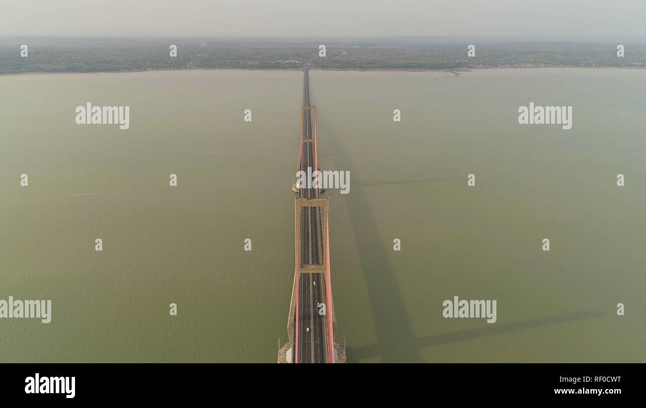 suspension bridge over madura strait with highway and car, surabaya ...