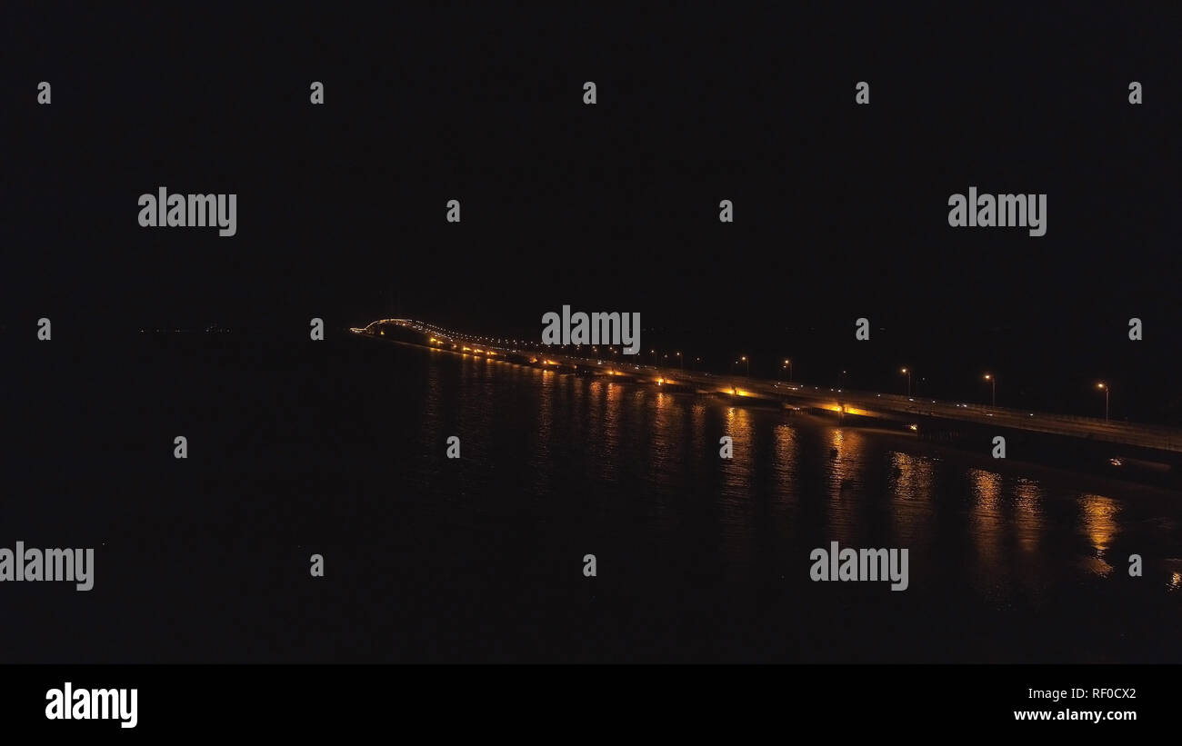 aerial view lighted bridge at night with highways and cars. suspension ...