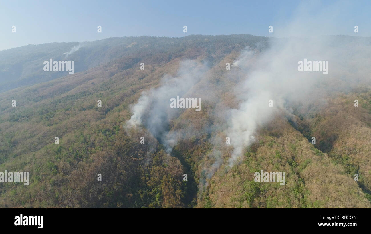 aerial view forest fire smoke on the slopes hills. wild fire in ...