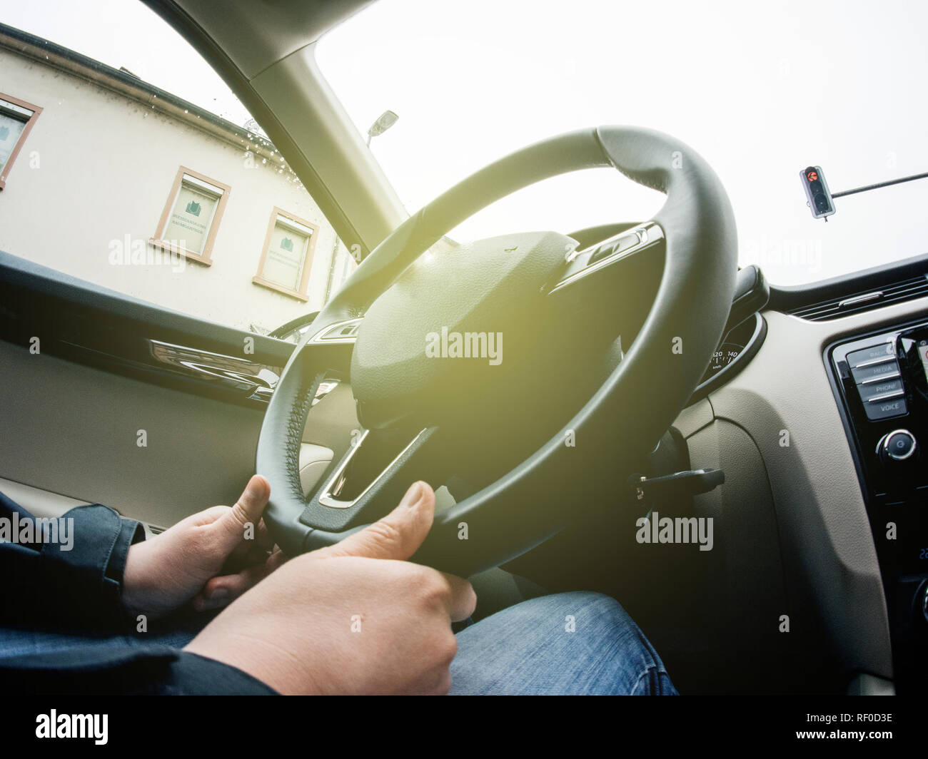 Young woman driving luxury car - view from the interior with ultra-wide ...