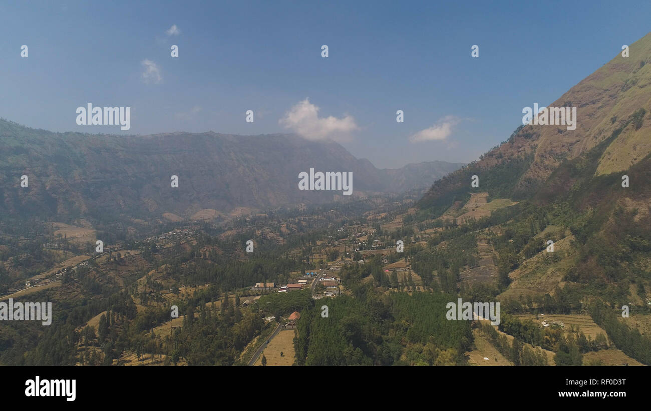 mountains with farmlands, village, fields with crops, trees. Aerial ...