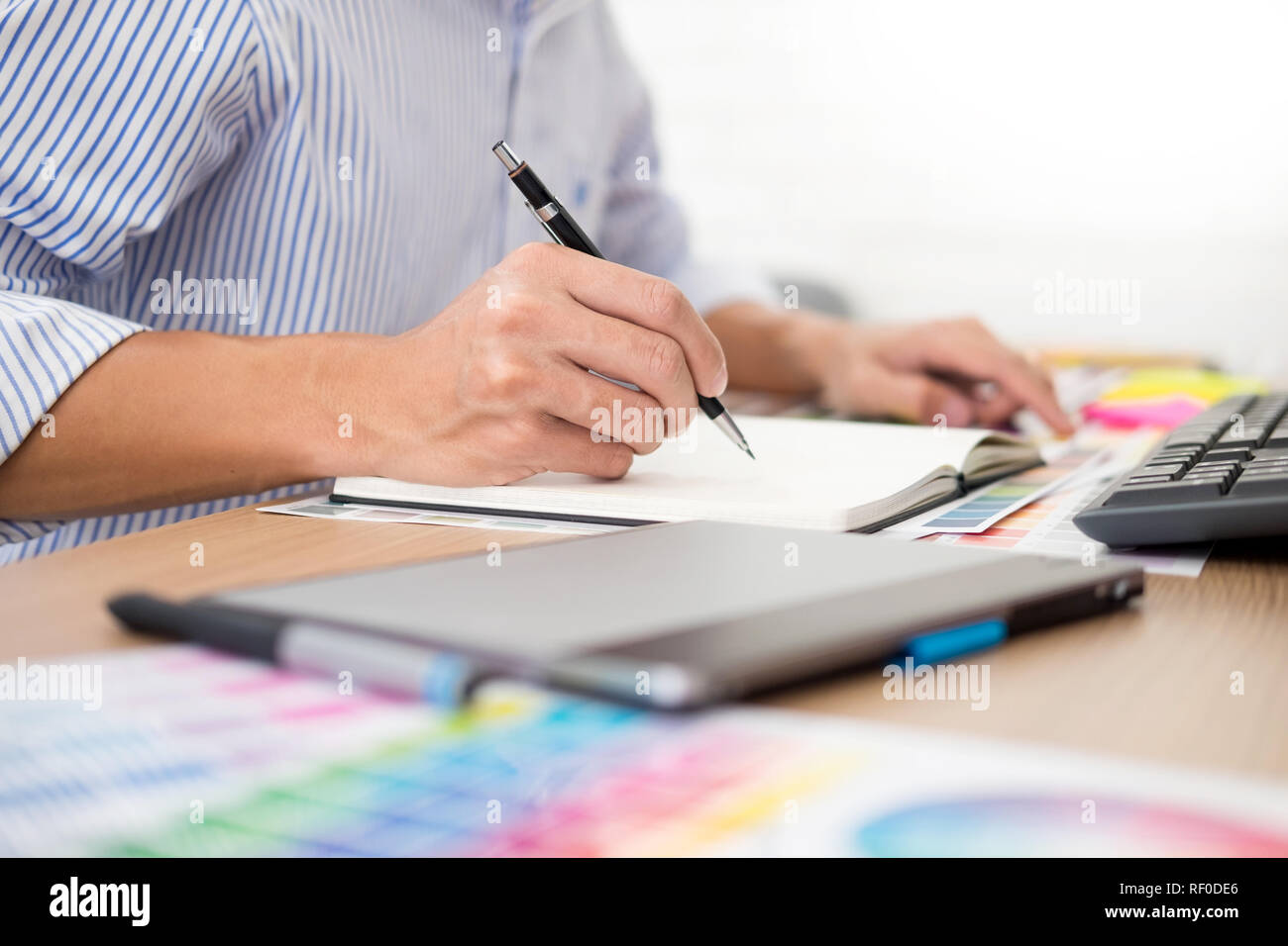 designer Editor at work drawing sketches a new project on graphic ...