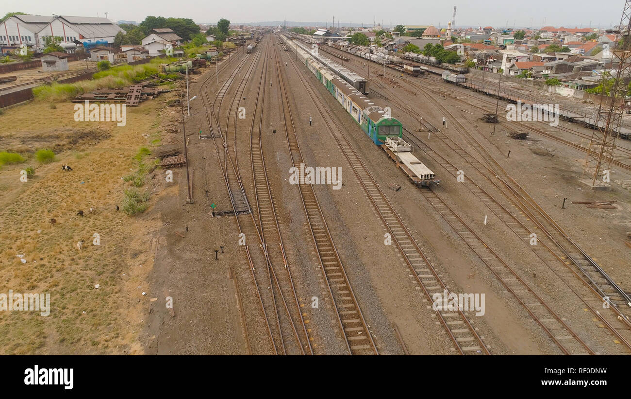 freight train with cisterns and containers on railway station Surabaya ...