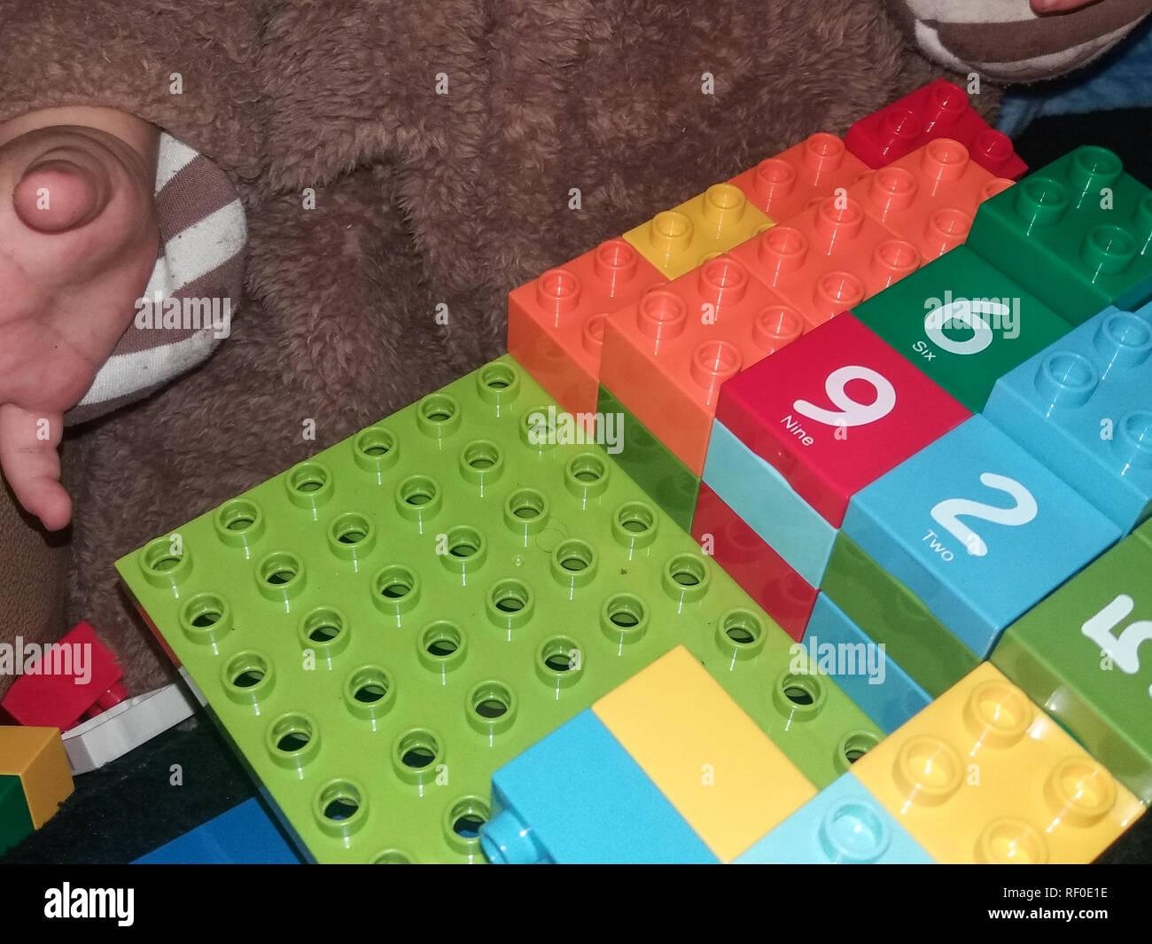 child tinny hand on lego blocks - early development concept Stock Photo ...