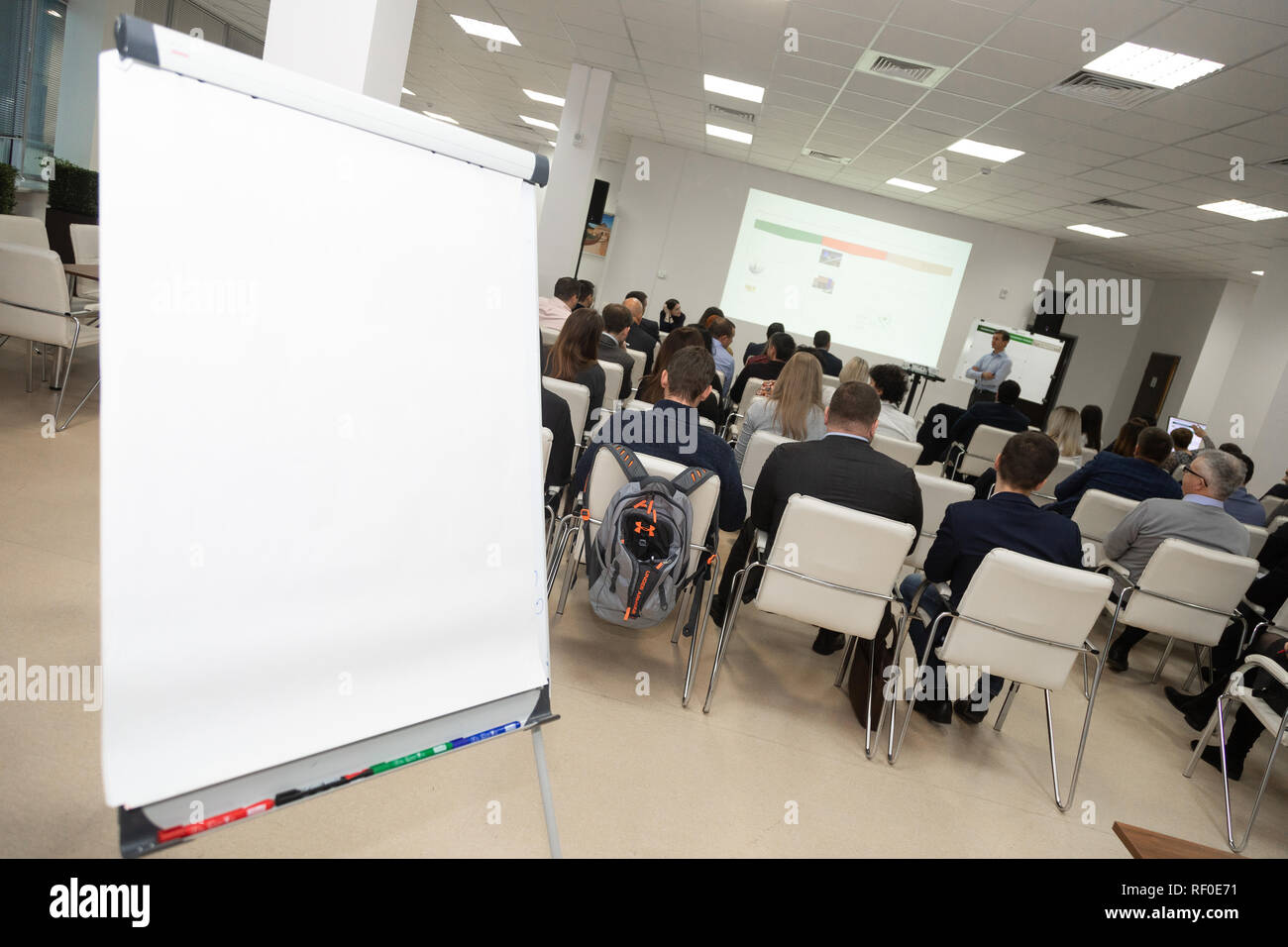 Board on background of audience in conference room. Business concept ...