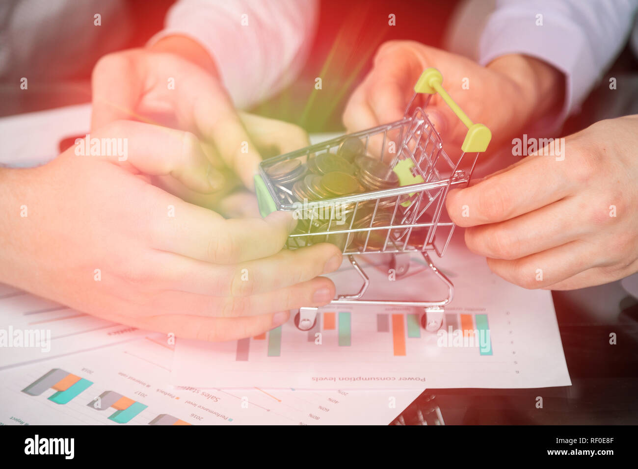 Men's hands pulled in different directions Dummy shopping cart filled ...