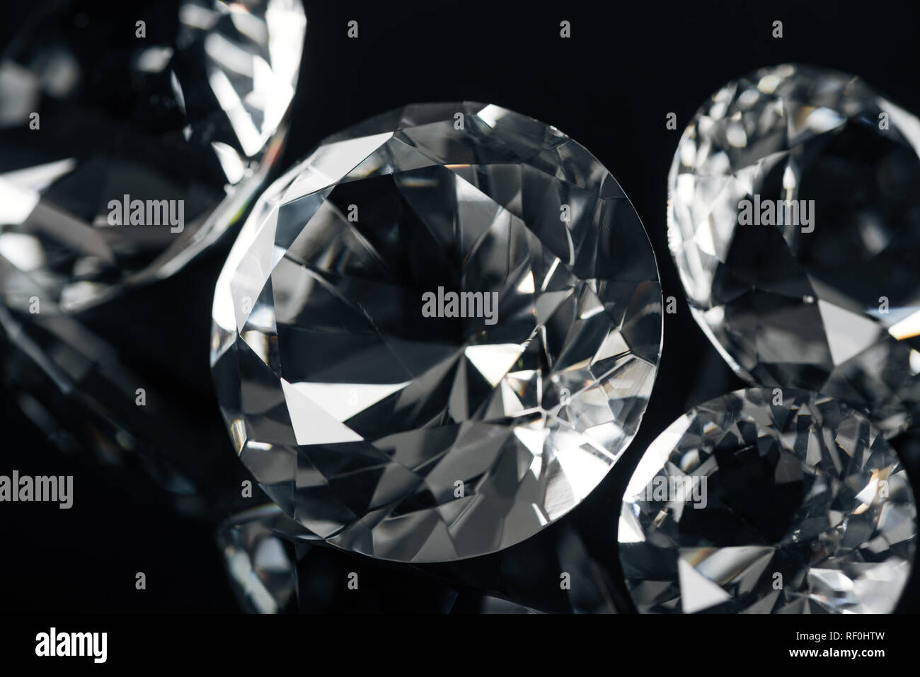 collection of clear diamonds isolated on black Stock Photo - Alamy