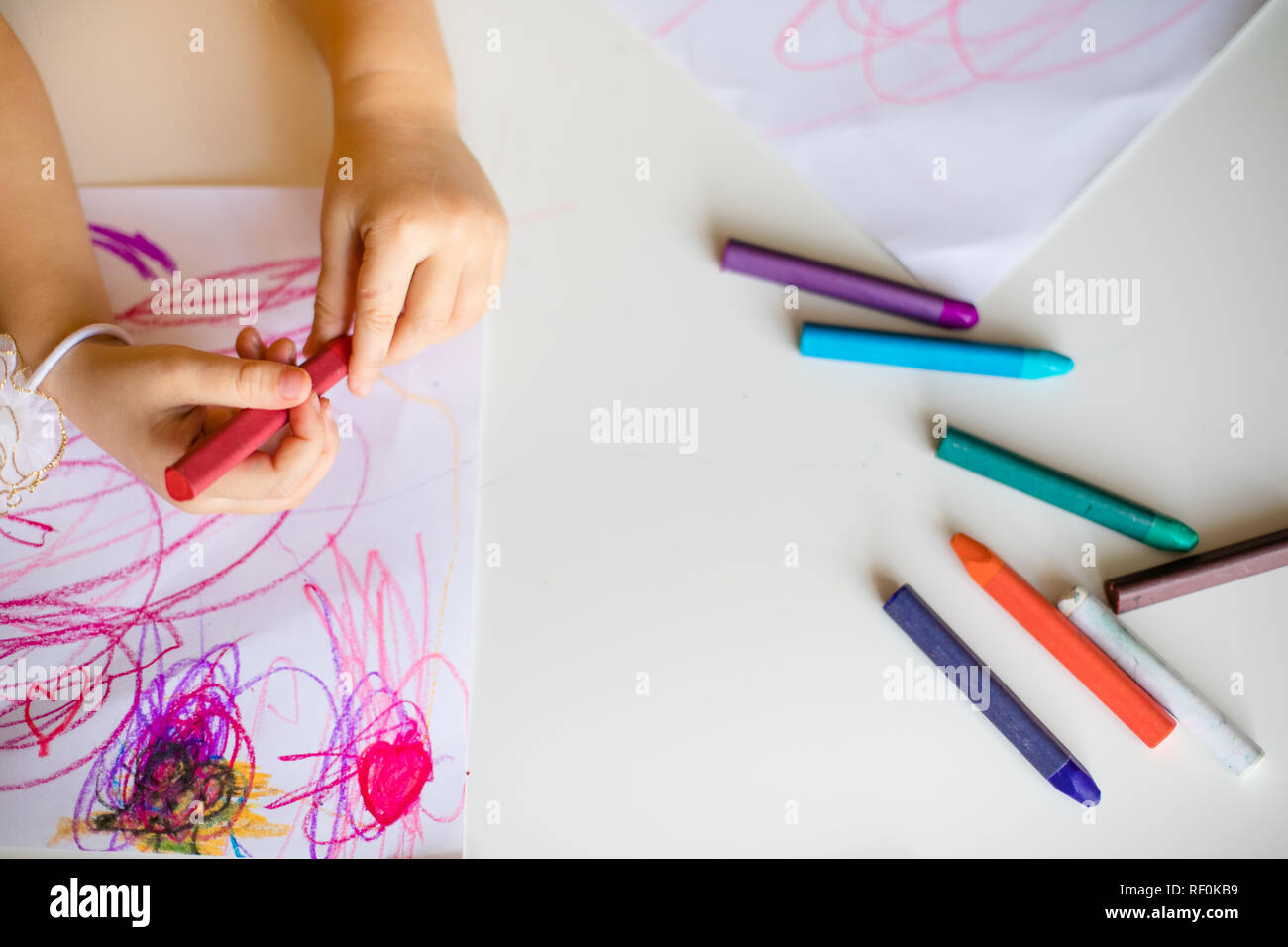nice little girl drawing with wax pastel Stock Photo - Alamy