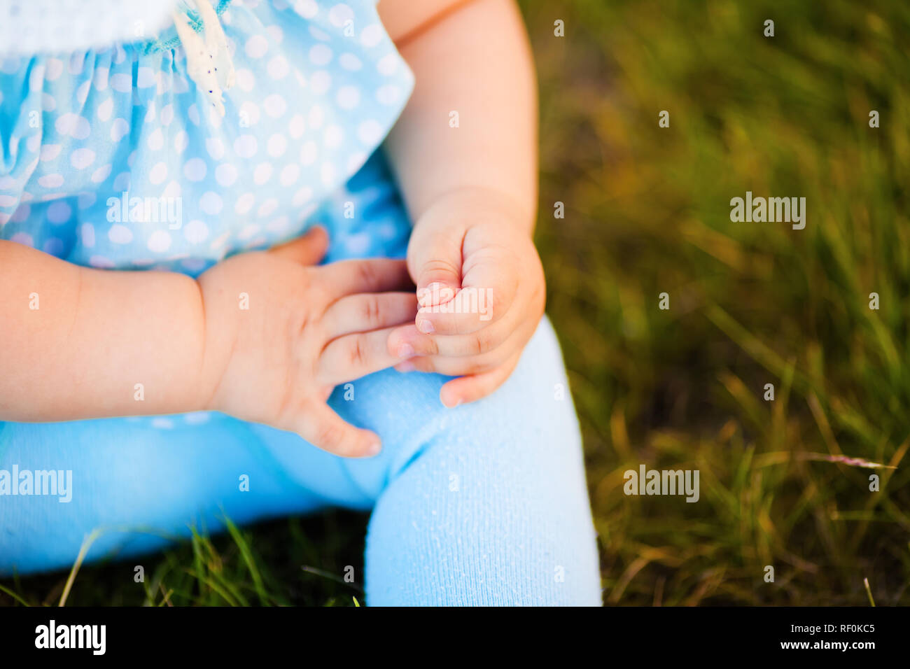 Fingers of baby in blue Stock Photo - Alamy