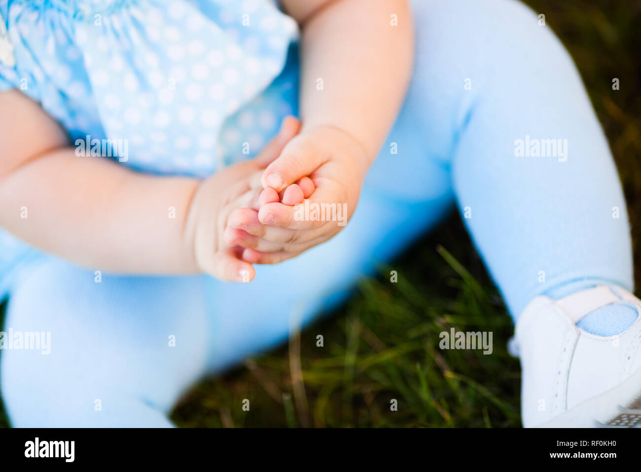Fingers of baby in blue Stock Photo - Alamy
