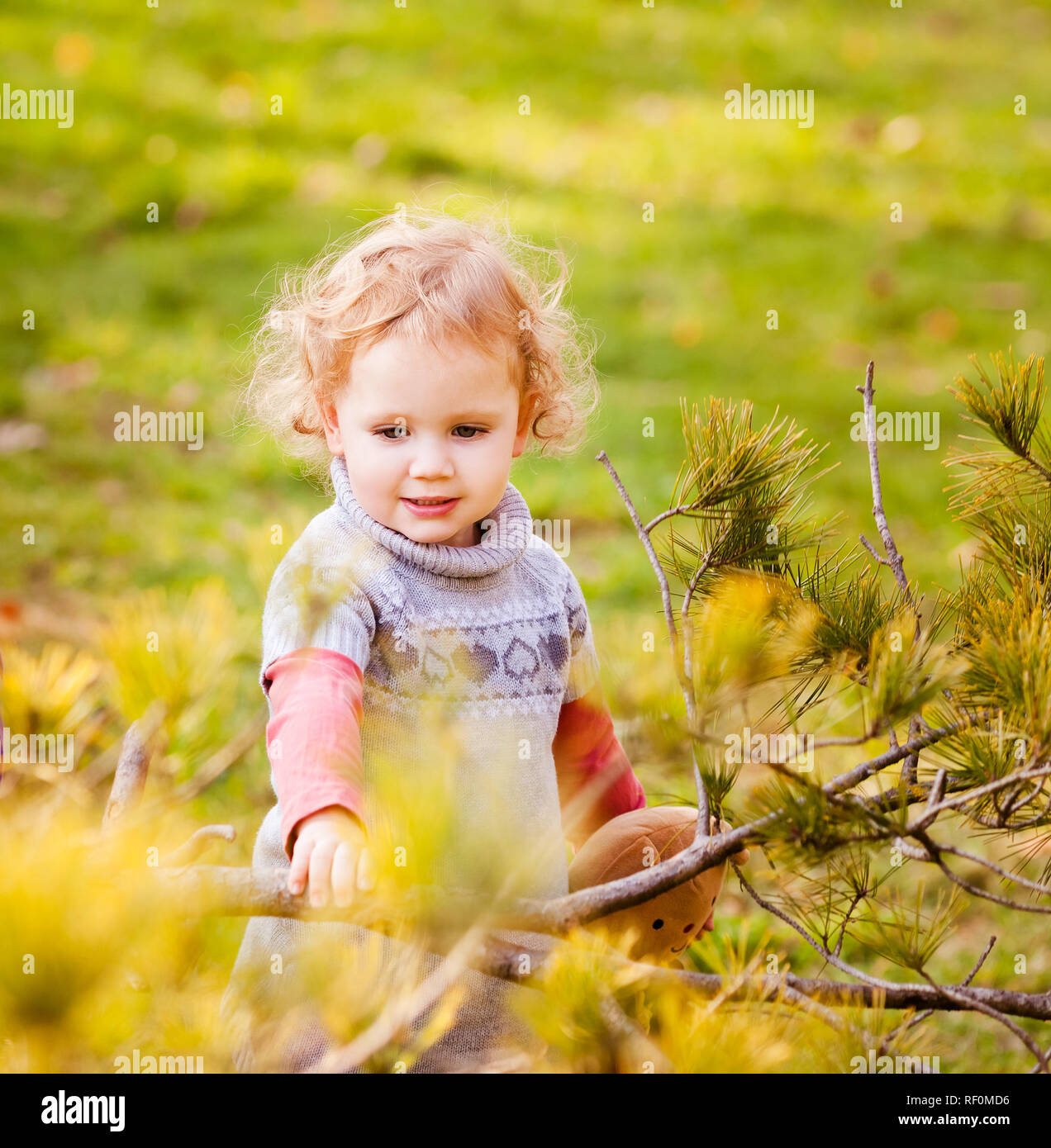 Adorable little girl with autumn leaves in the beauty park Stock Photo ...