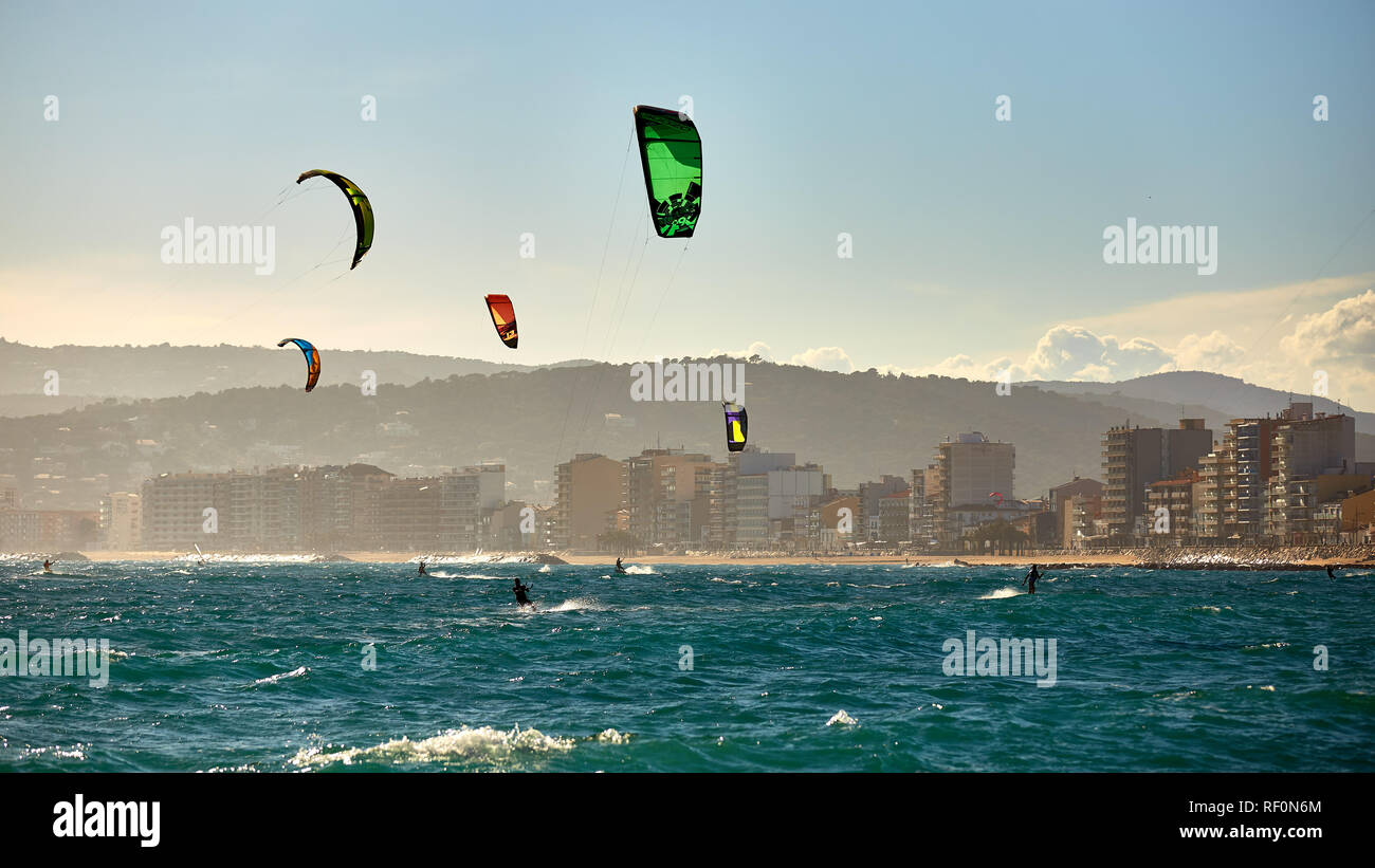 Many kite parachute on the beach in Costa Brava of Spain, village ...