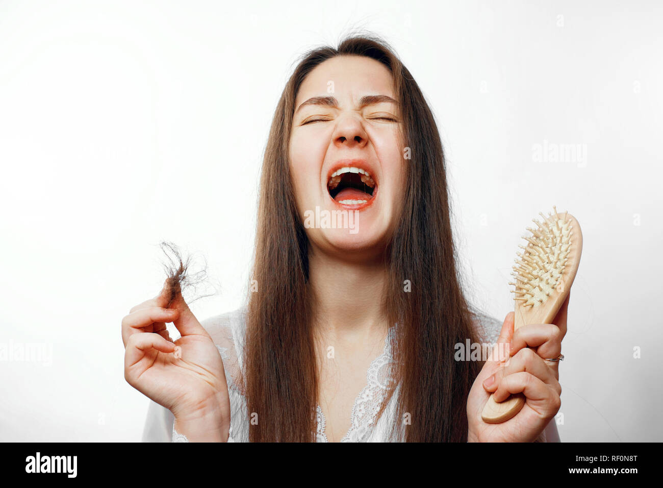 falling hair in woman hand, young woman cry hysterics Stock Photo - Alamy