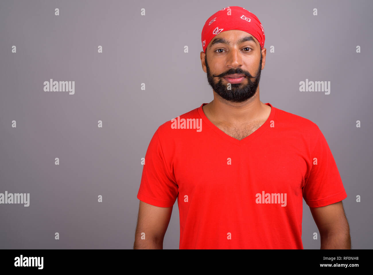 Portrait of young handsome Indian man wearing red shirt Stock Photo - Alamy