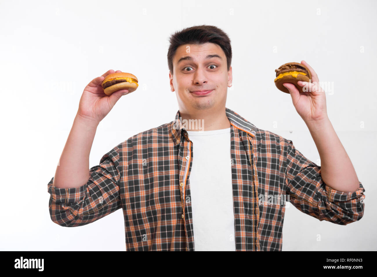 man holds burgers in his hands Stock Photo - Alamy