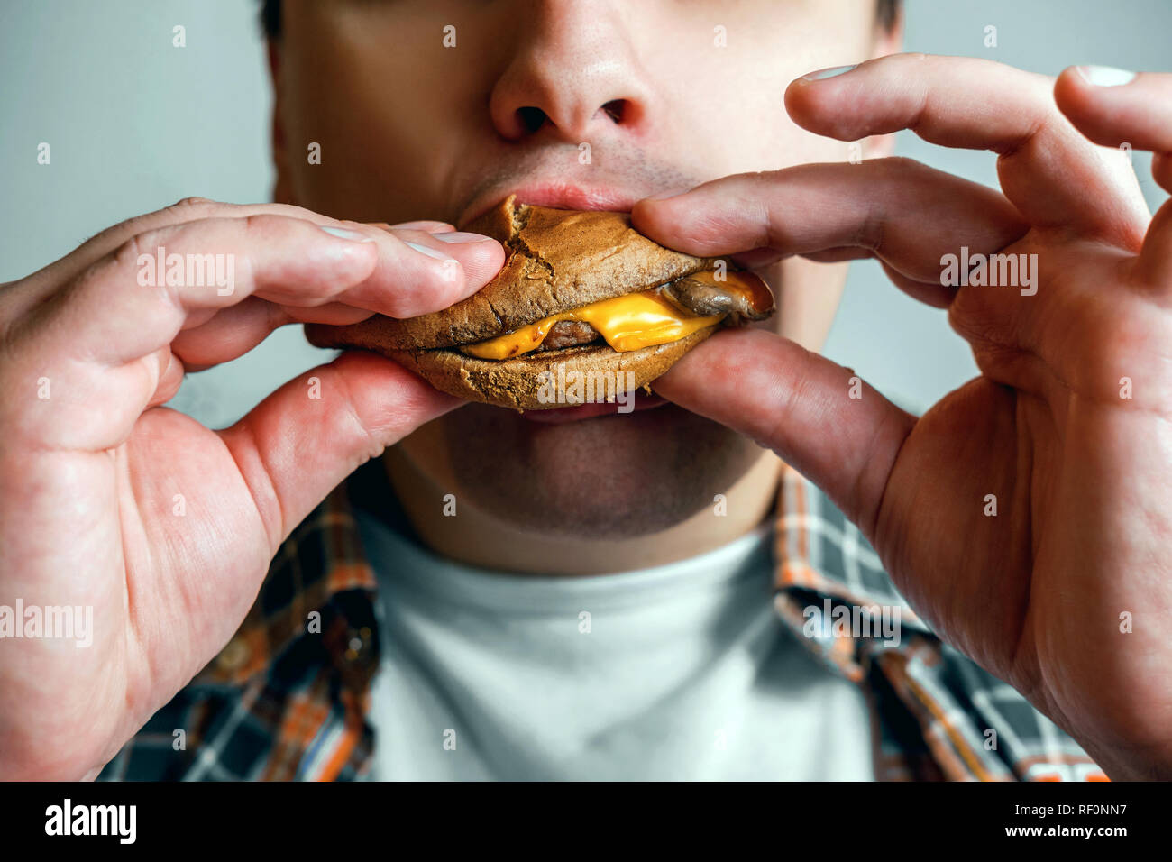 close up burger in mouth of man Stock Photo - Alamy