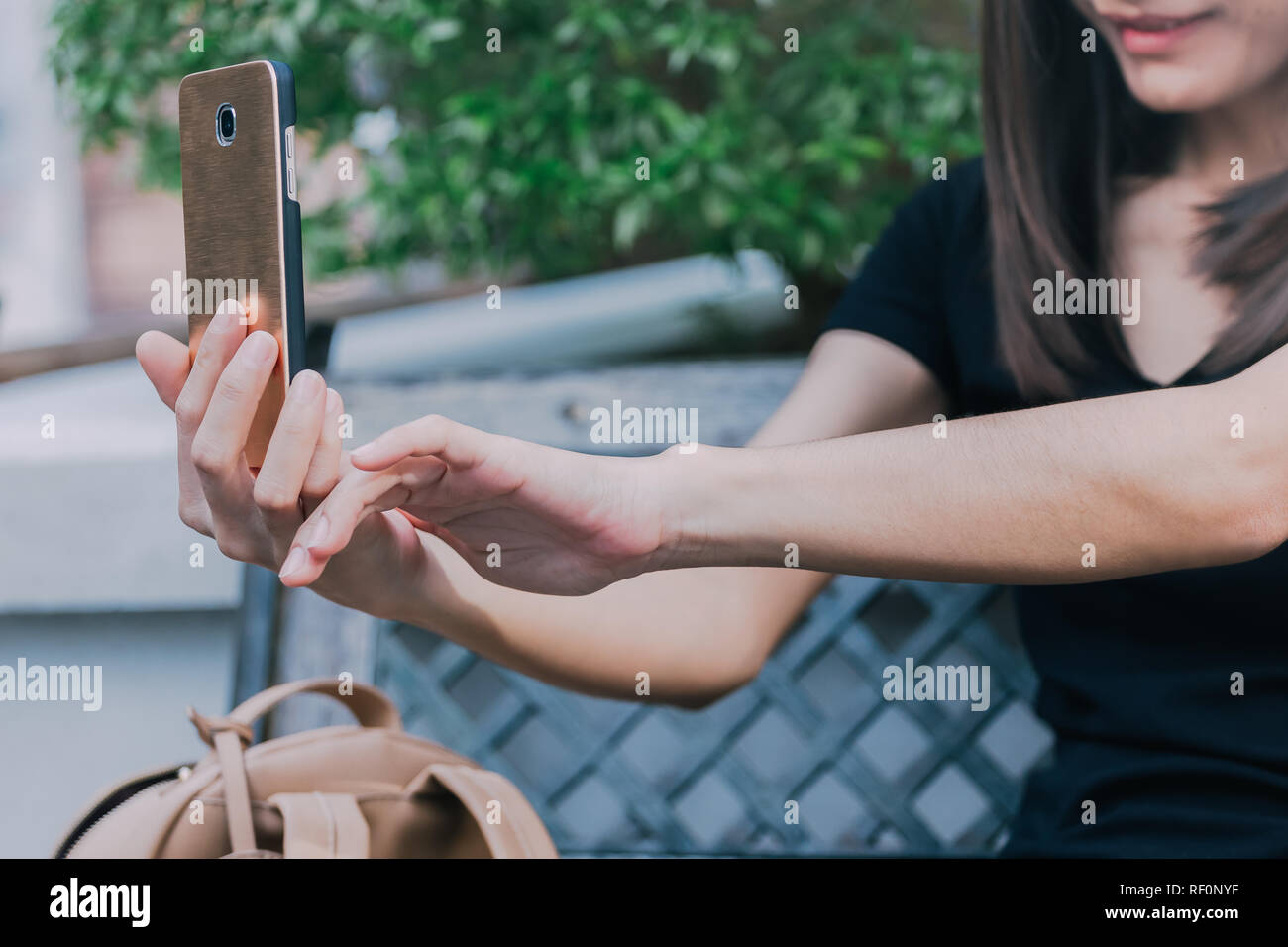 Girl using mobile phone selfies in places outdoors happily Stock Photo ...