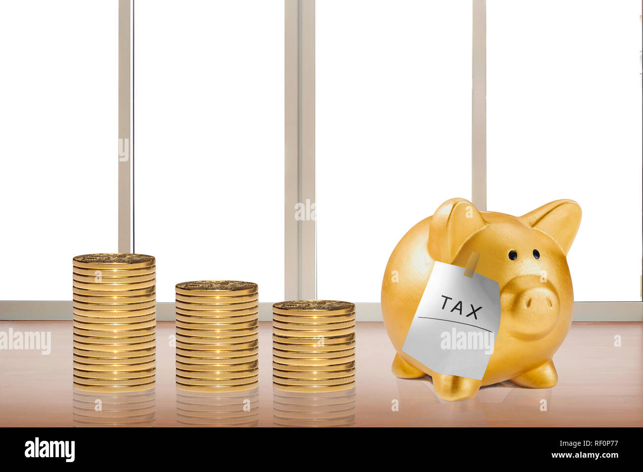 Stack of gold coins with taxes note on piggy bank. Taxes concept Stock ...