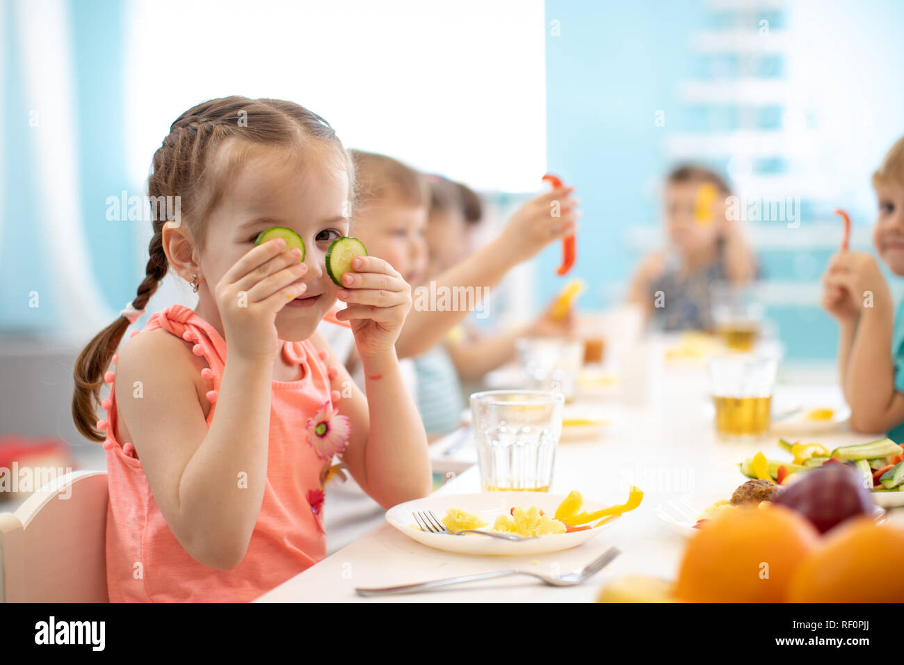 funny children eating healthy food in kindergarten or daycare Stock ...