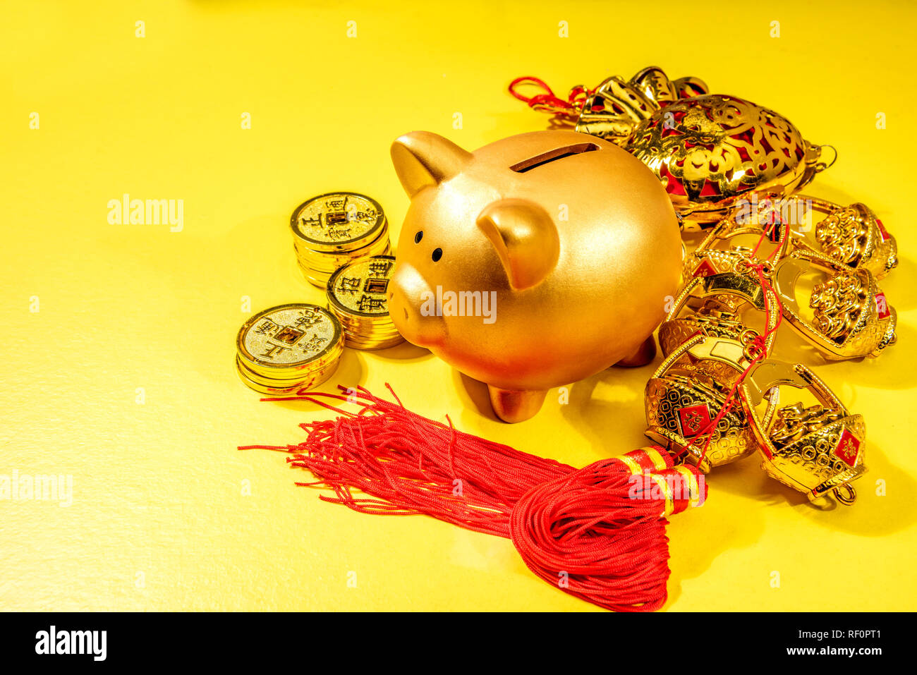 Piggy bank with golden coin and chinese ornament over yellow background ...