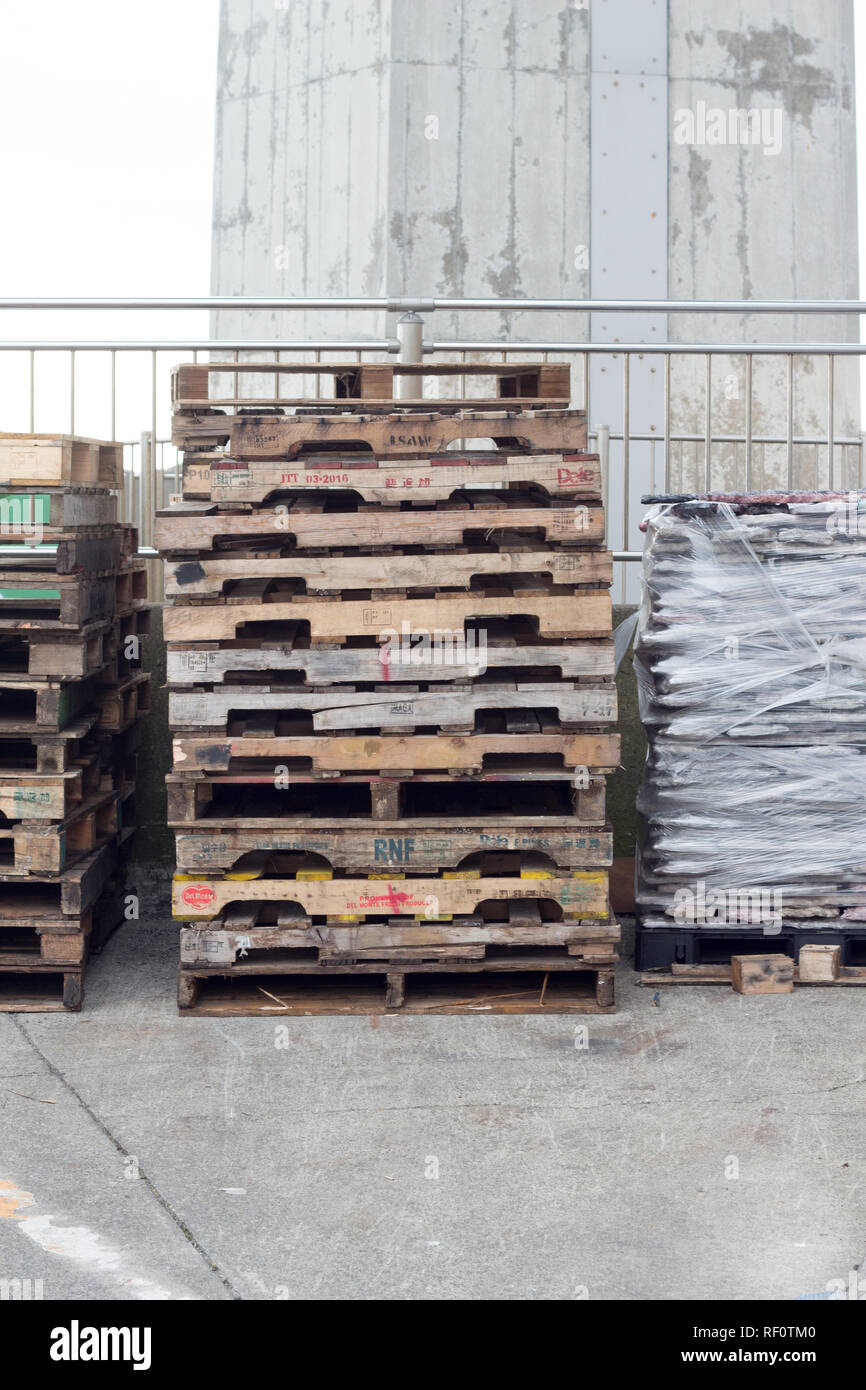 Piled old wooden pallets at harbor Stock Photo - Alamy