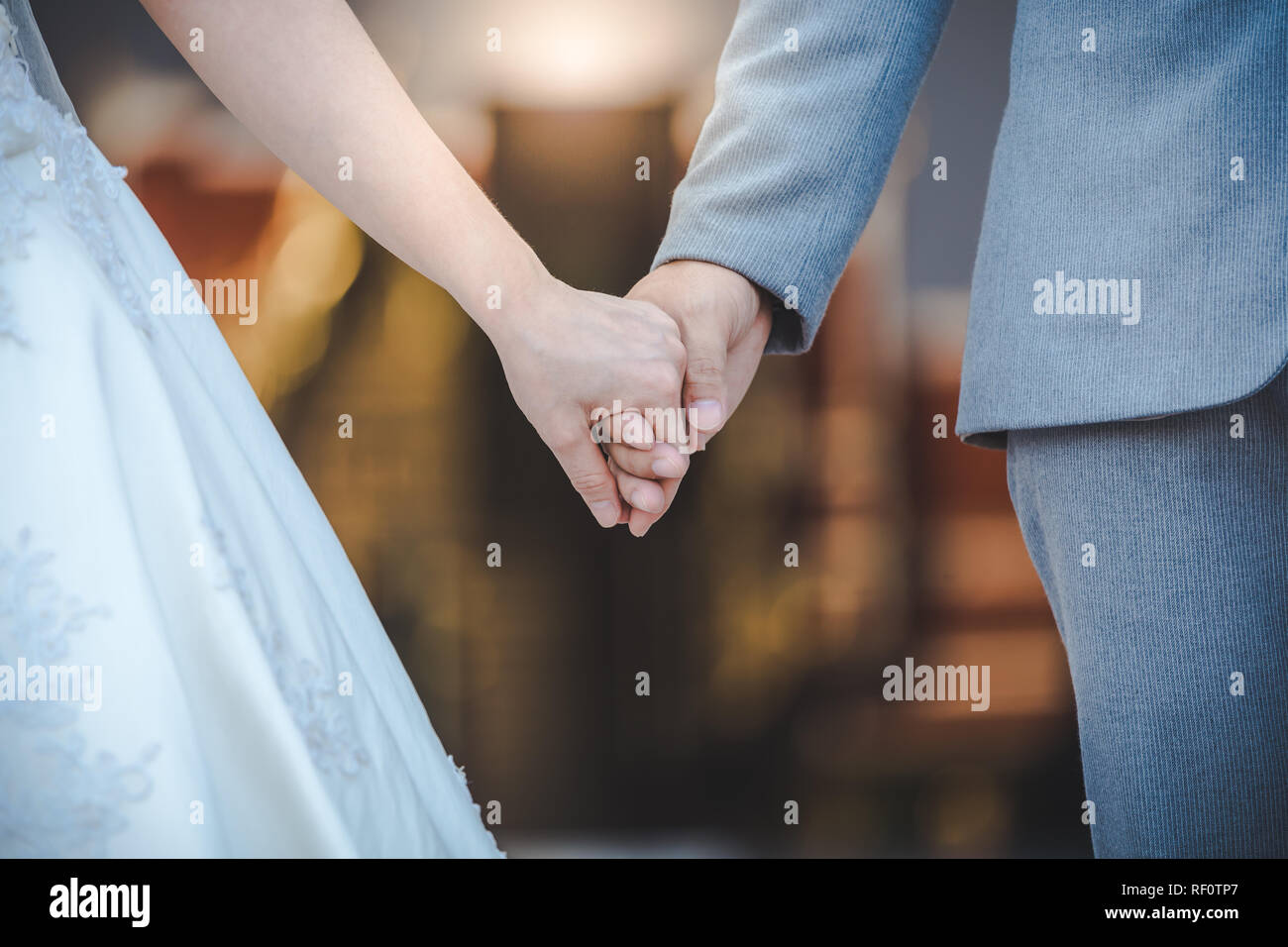 Bride and bridegroom married hands when sun is falling. background.Soft ...