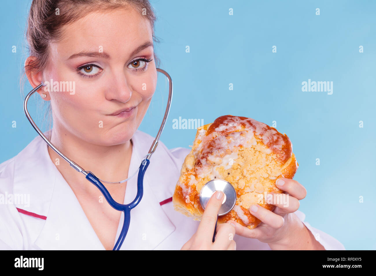 Unhappy dietitian nutritionist checking examine sweet roll bun with ...