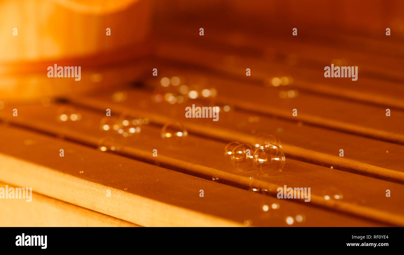 Relax and spa concept. Soap bubbles on wooden bench background in sauna ...